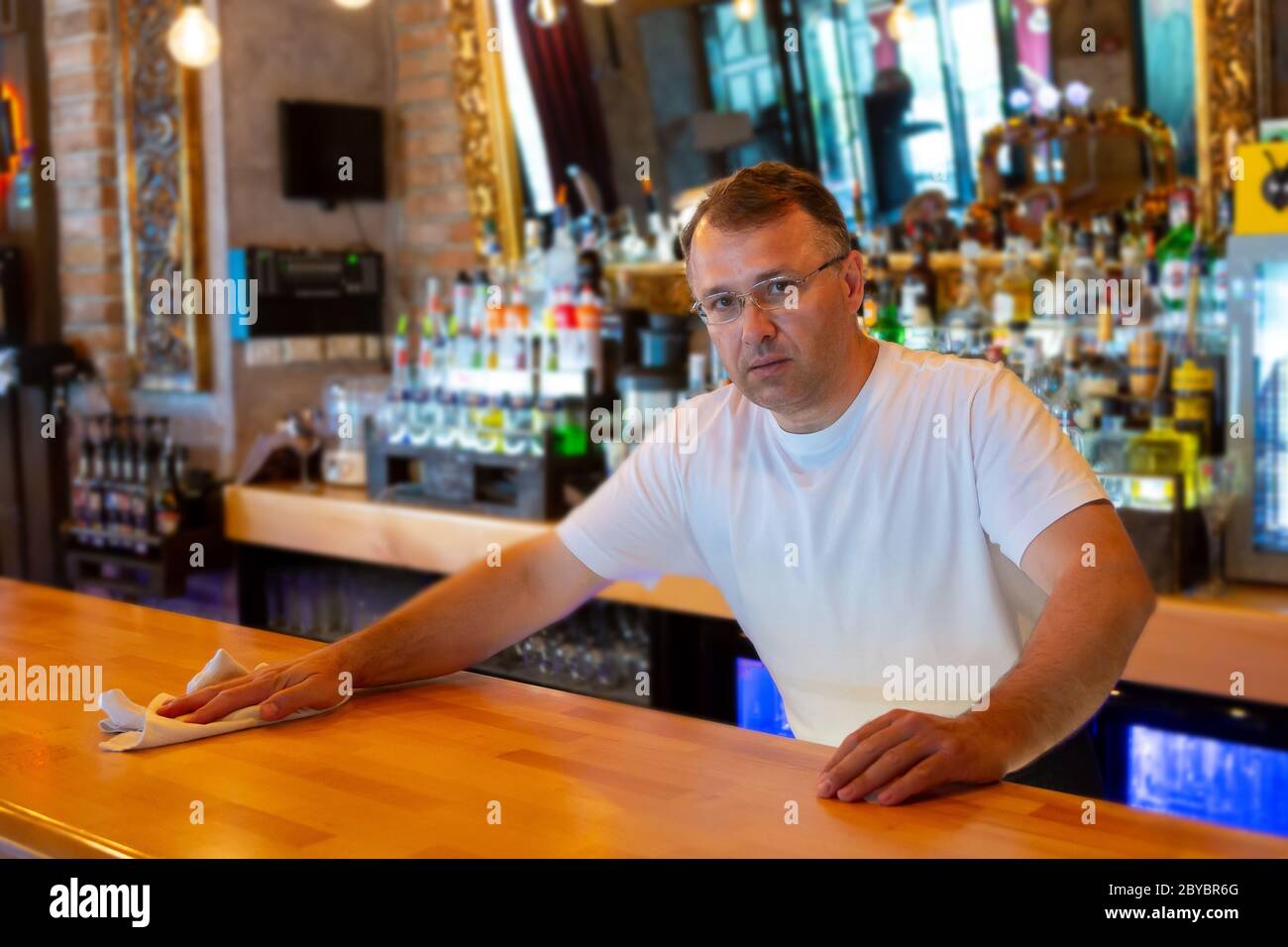 Bartender Cleaning the Bar Stock Photo - Alamy