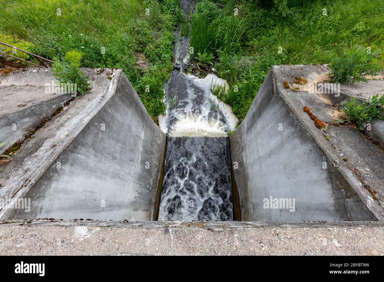 Concrete dam seen from above. Small hydropower plant. Spring season ...