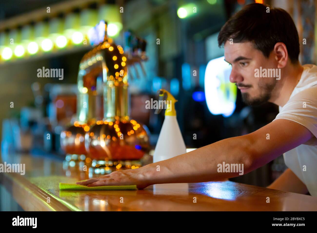 Young Bartender Cleaning the Bar Stock Photo - Alamy