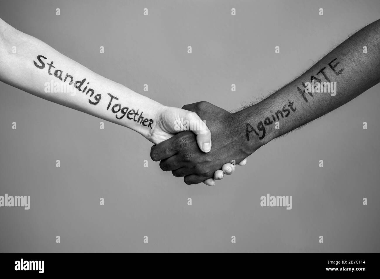 Handshake between black and white human woman and male hands with ...