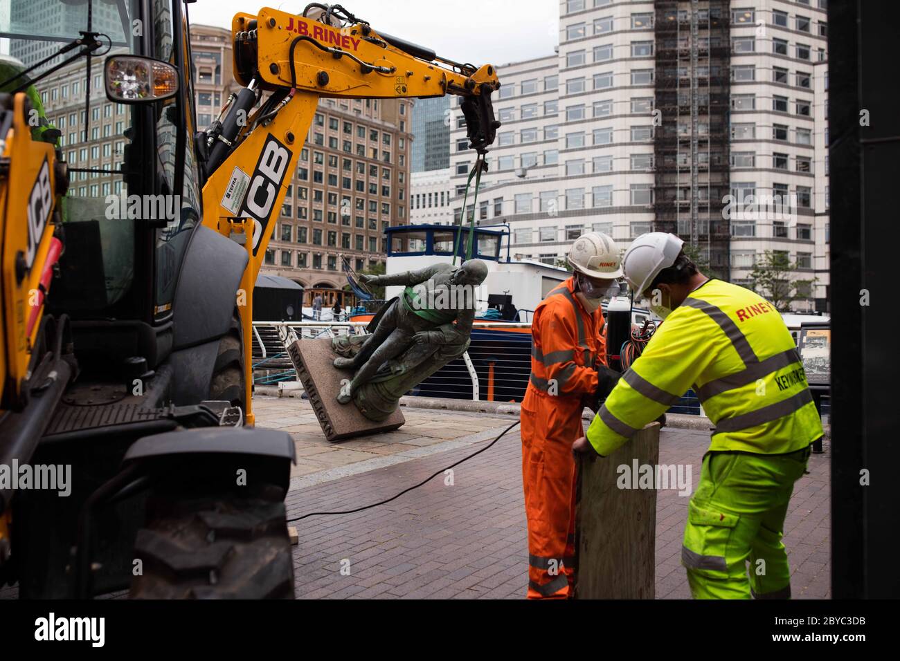 The statue of Robert Milligan is lifted from its plinth using a JCB in ...