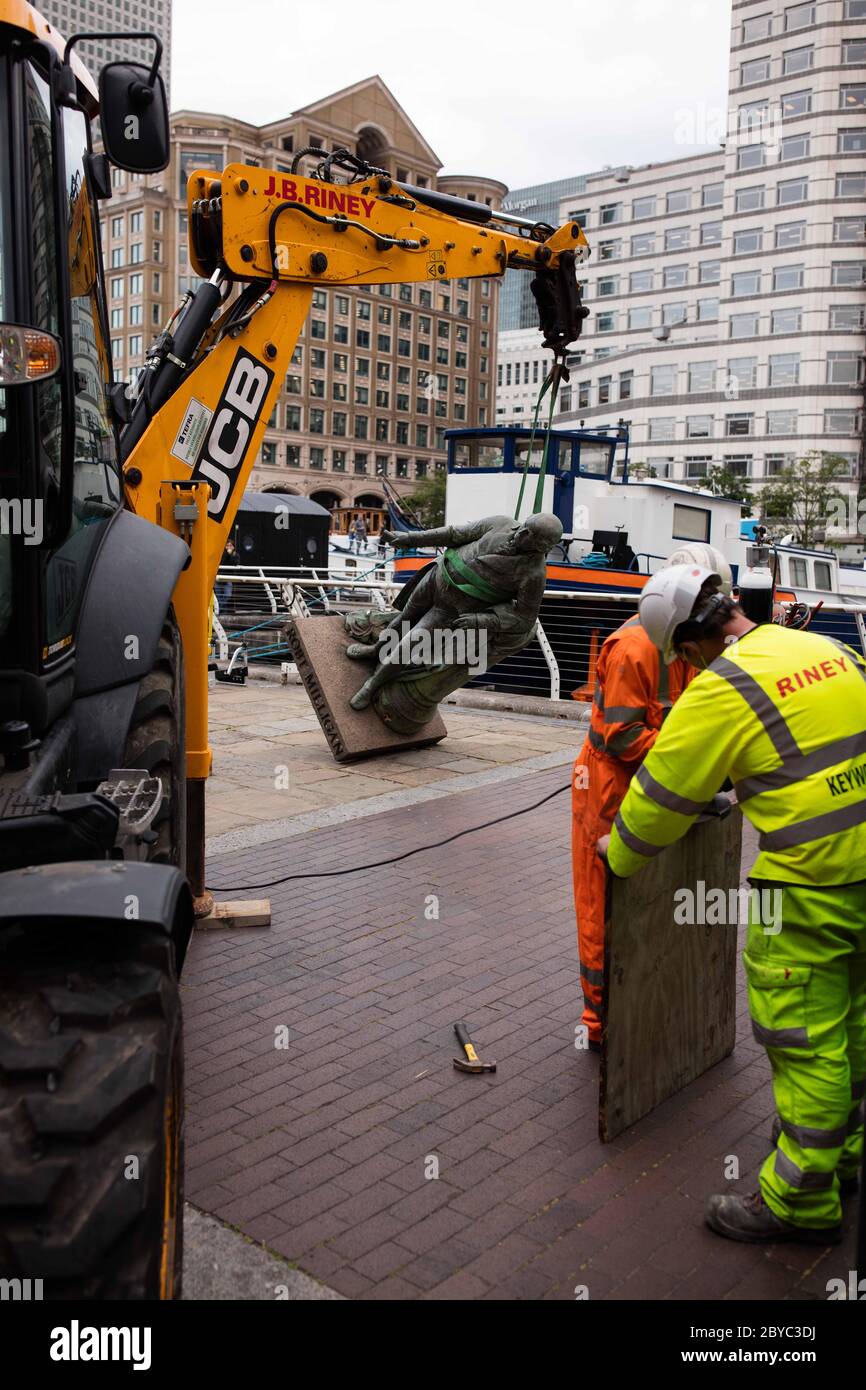 The statue of Robert Milligan is lifted from its plinth using a JCB in ...