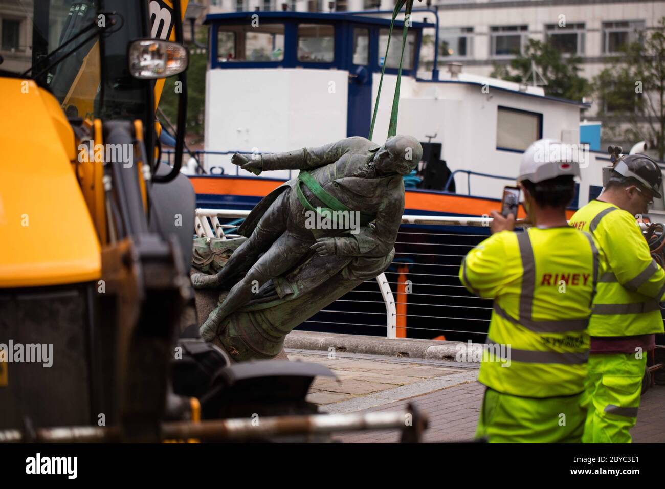The statue of Robert Milligan is lifted from its plinth using a JCB in ...