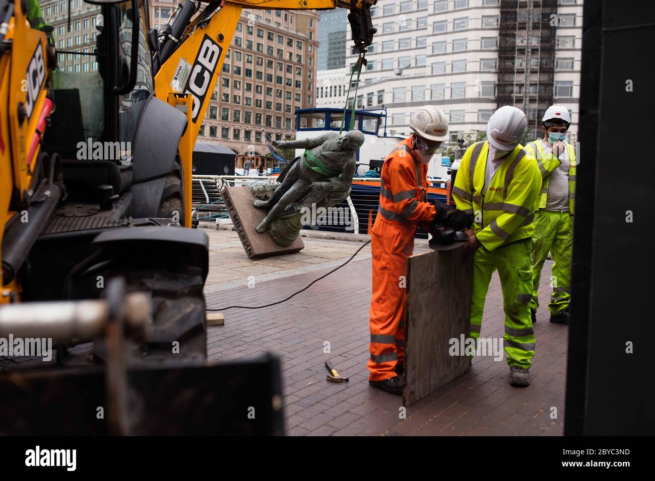 The statue of Robert Milligan is lifted from its plinth using a JCB in ...