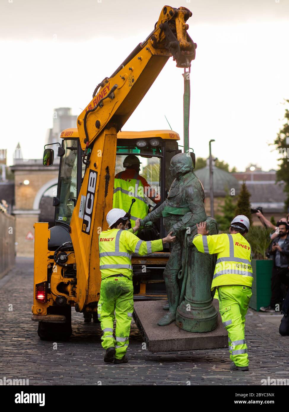The statue of Robert Milligan is lifted from its plinth using a JCB in ...