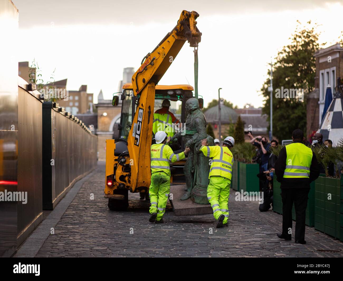 The statue of Robert Milligan is lifted from its plinth using a JCB in ...