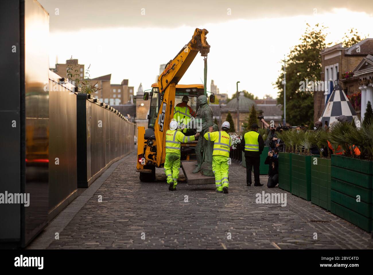 The statue of Robert Milligan is lifted from its plinth using a JCB in ...
