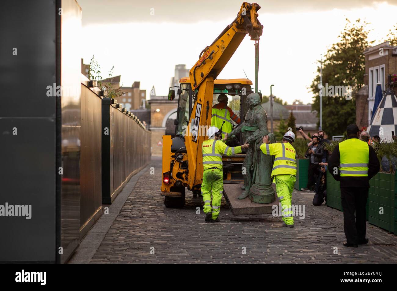 The statue of Robert Milligan is lifted from its plinth using a JCB in ...