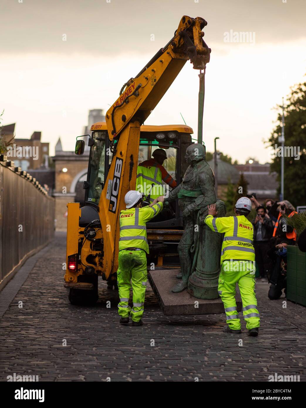The statue of Robert Milligan is lifted from its plinth using a JCB in ...