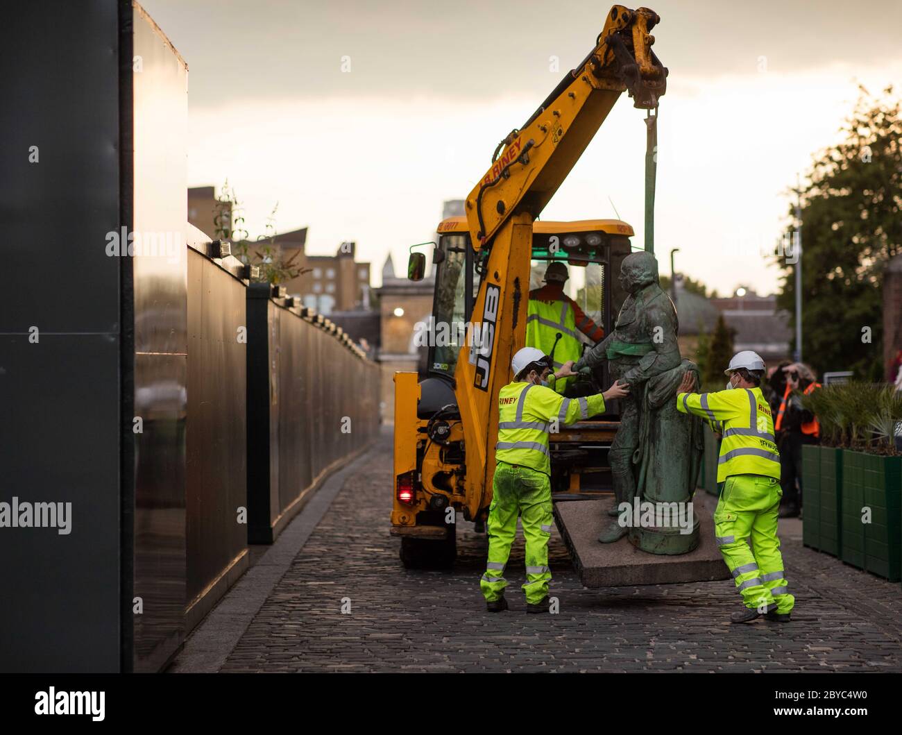 The statue of Robert Milligan is lifted from its plinth using a JCB in ...