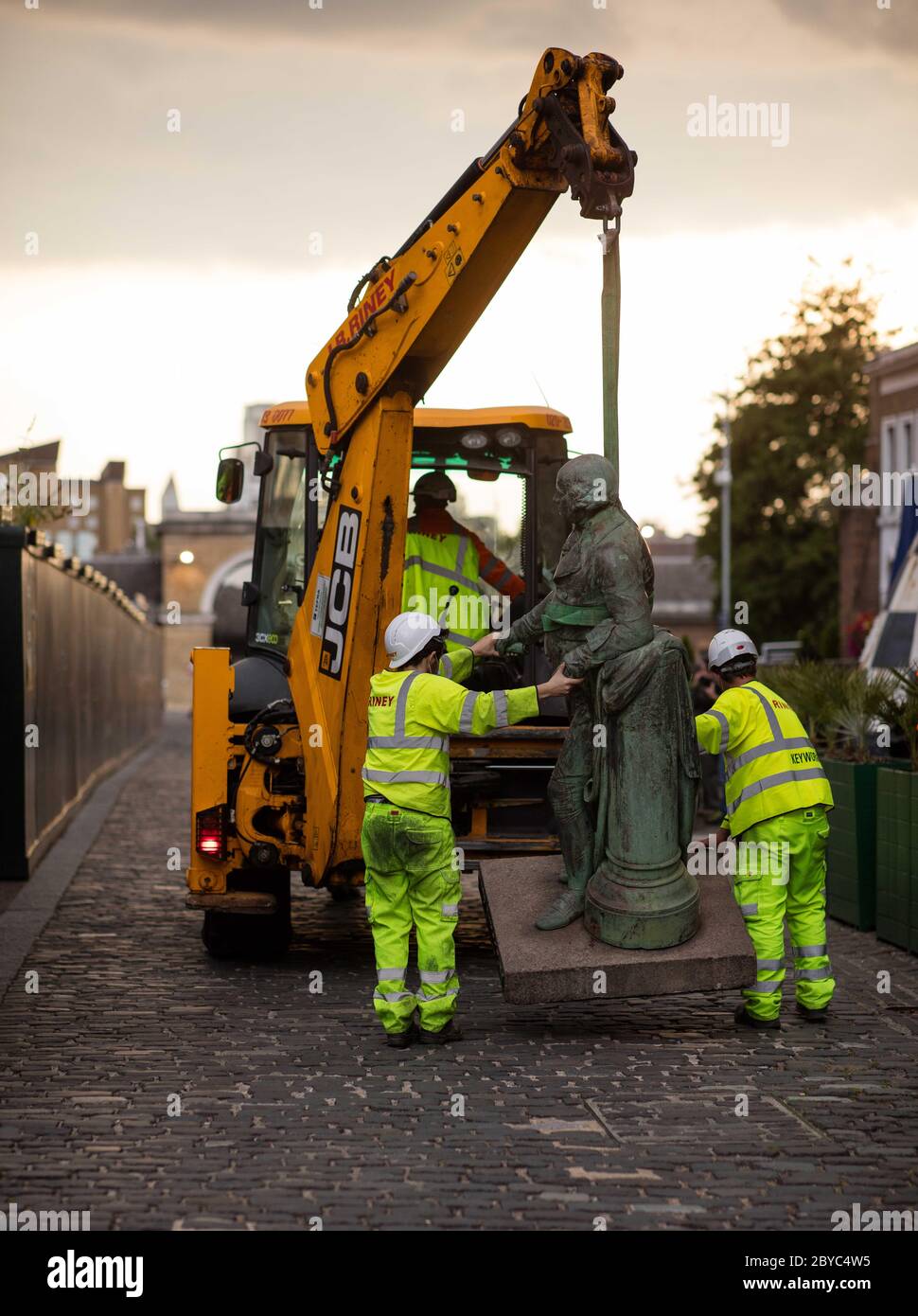 The statue of Robert Milligan is lifted from its plinth using a JCB in ...