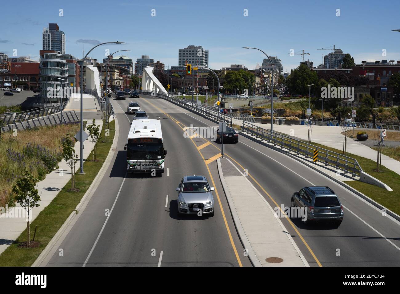 A view over traffic, including a transit bus, on Esquimalt Road to the ...