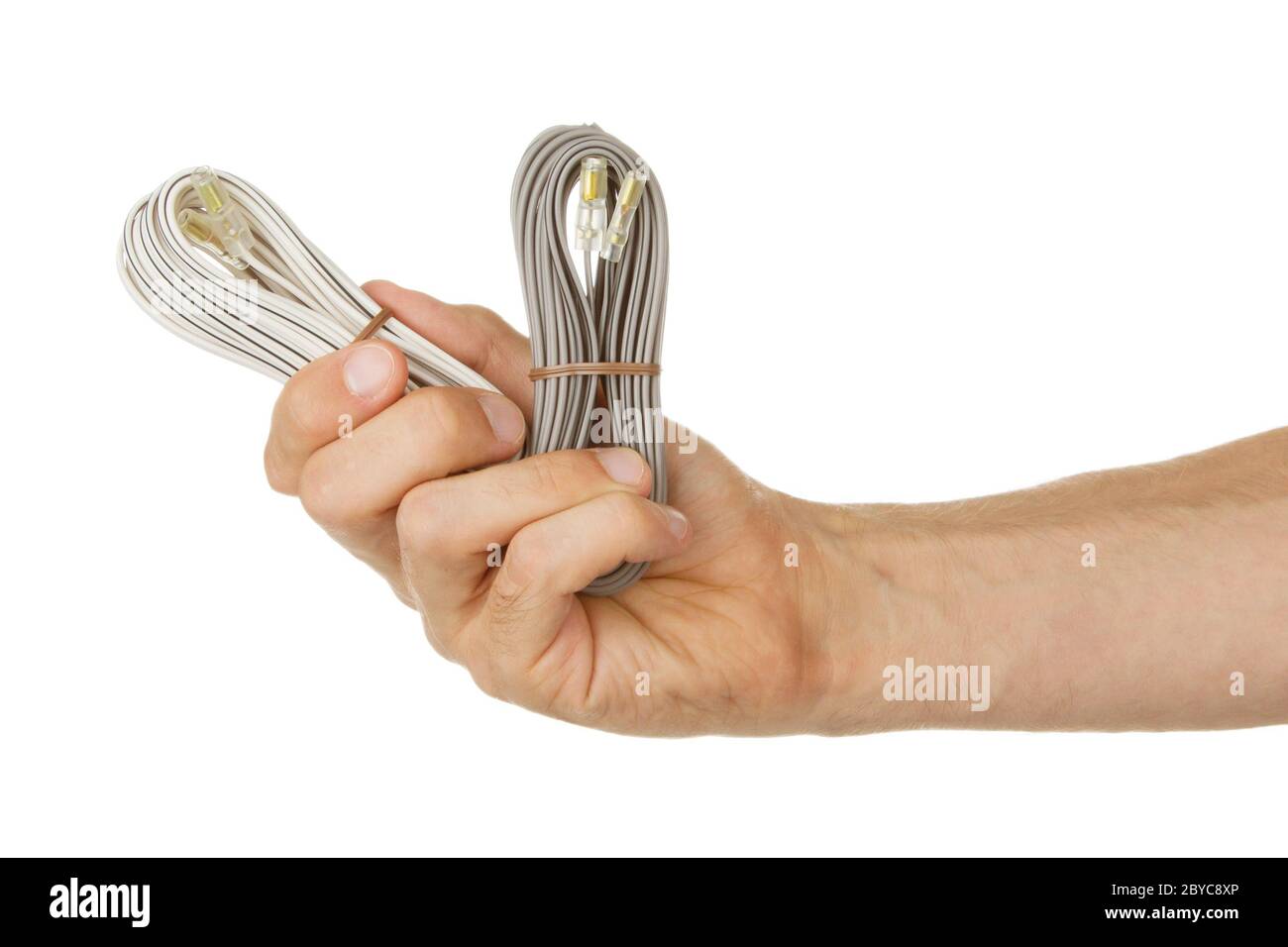 Speaker cable in a hand, isolated Stock Photo - Alamy