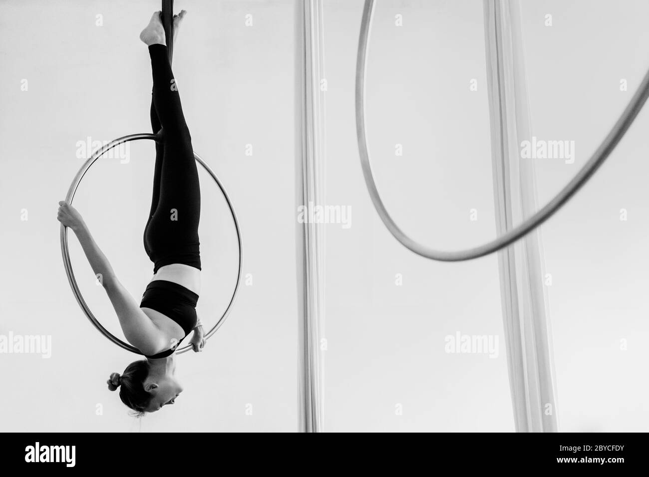 A Colombian aerial dancer hangs upside-down on aerial hoop during a ...