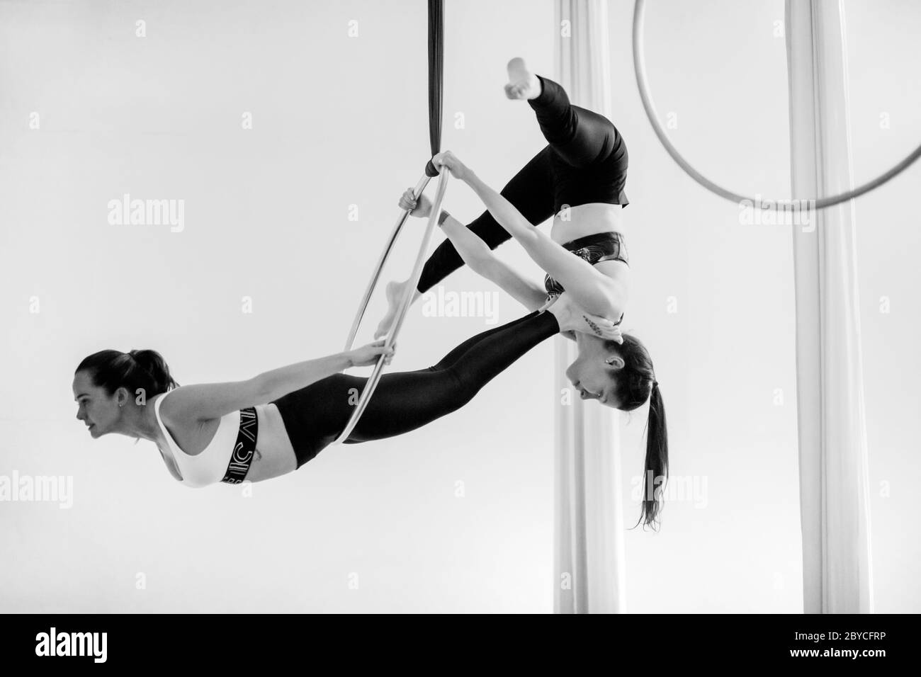 Colombian aerial dancers perform a duo act on aerial hoop during a ...