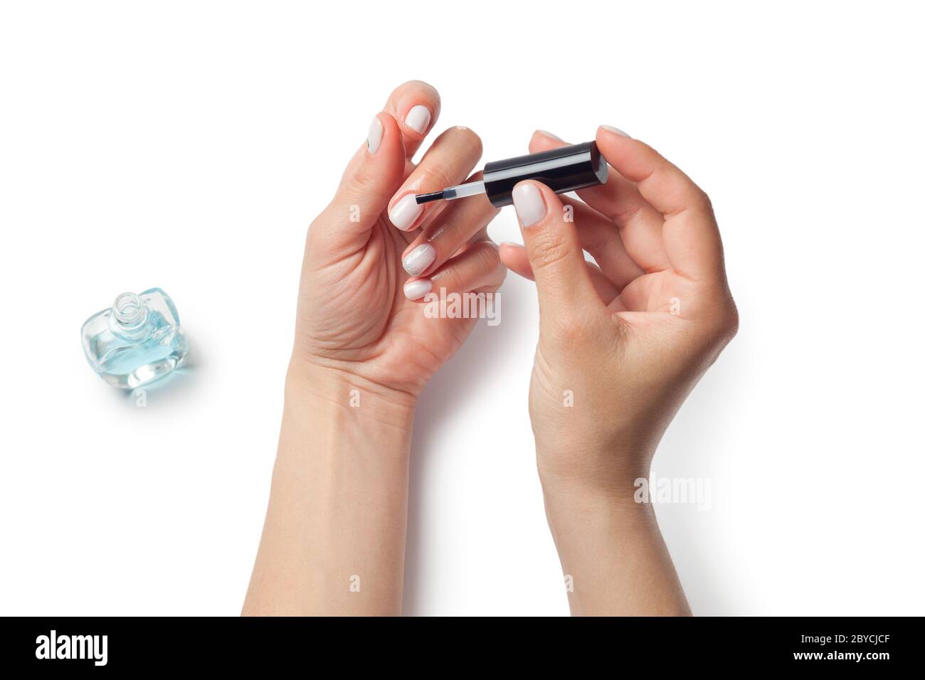 Female hands apply oil to nails. Cuticle oil. Isolated on a white ...
