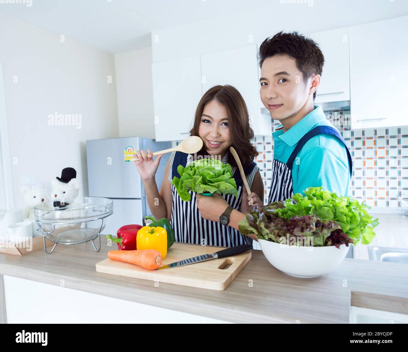 happy couples in kitchen Stock Photo - Alamy