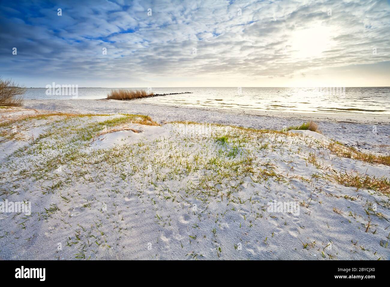 sunshine over sand dunes on the beach Stock Photo - Alamy