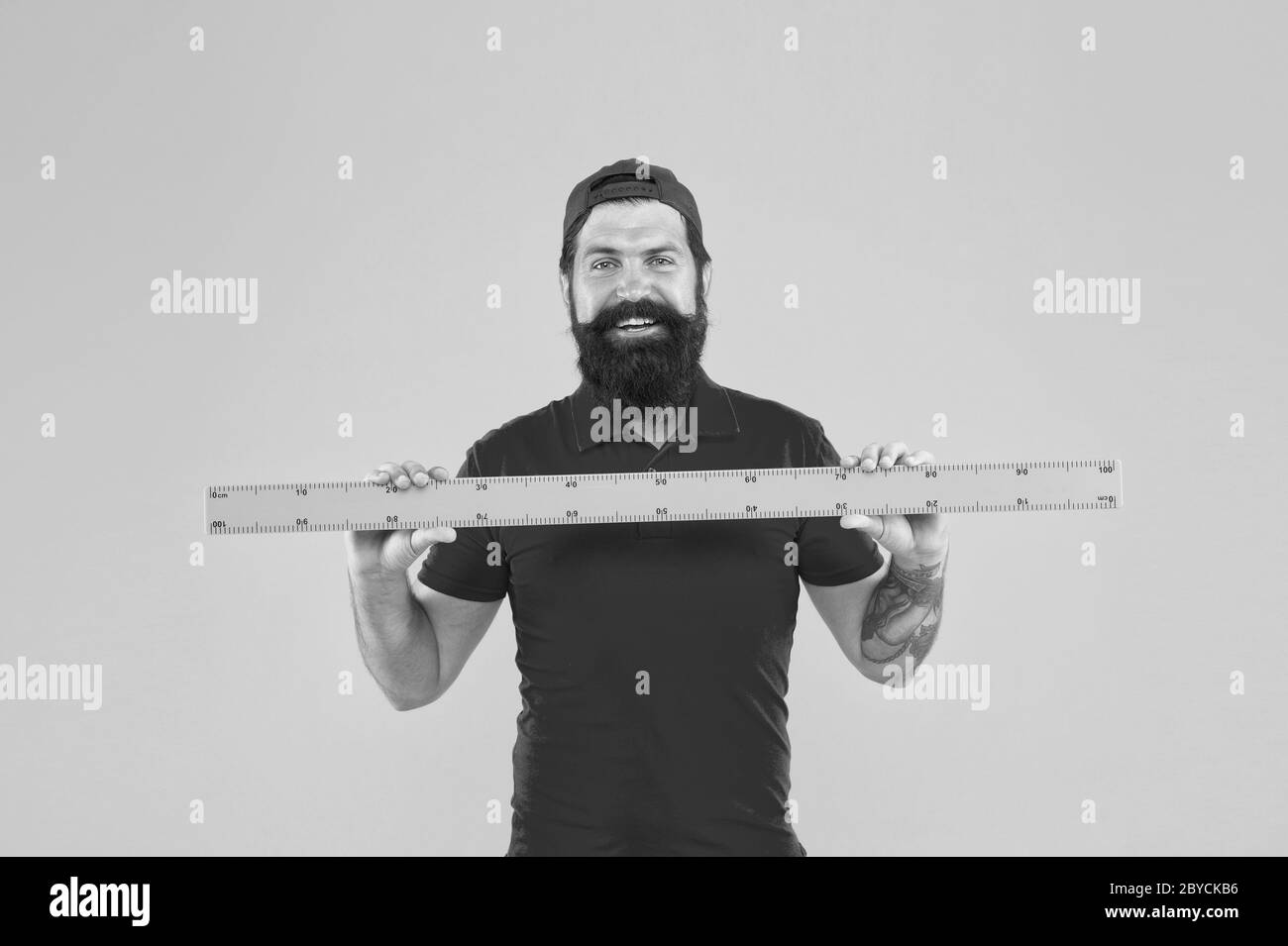 happy about size. Bearded man with big measuring instrument. Measuring ...