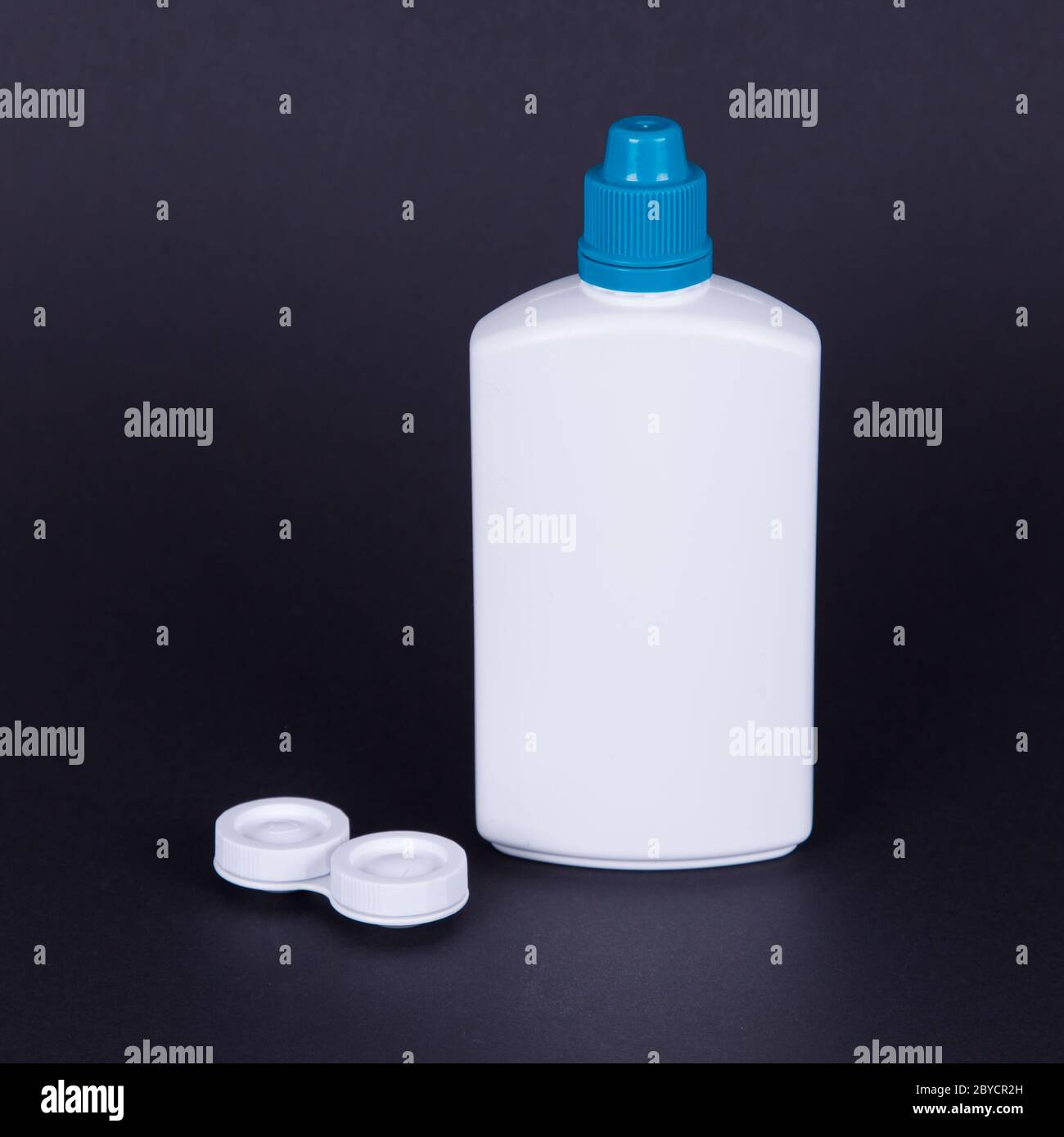 Lens casing and bottle of water isolated on black Stock Photo - Alamy