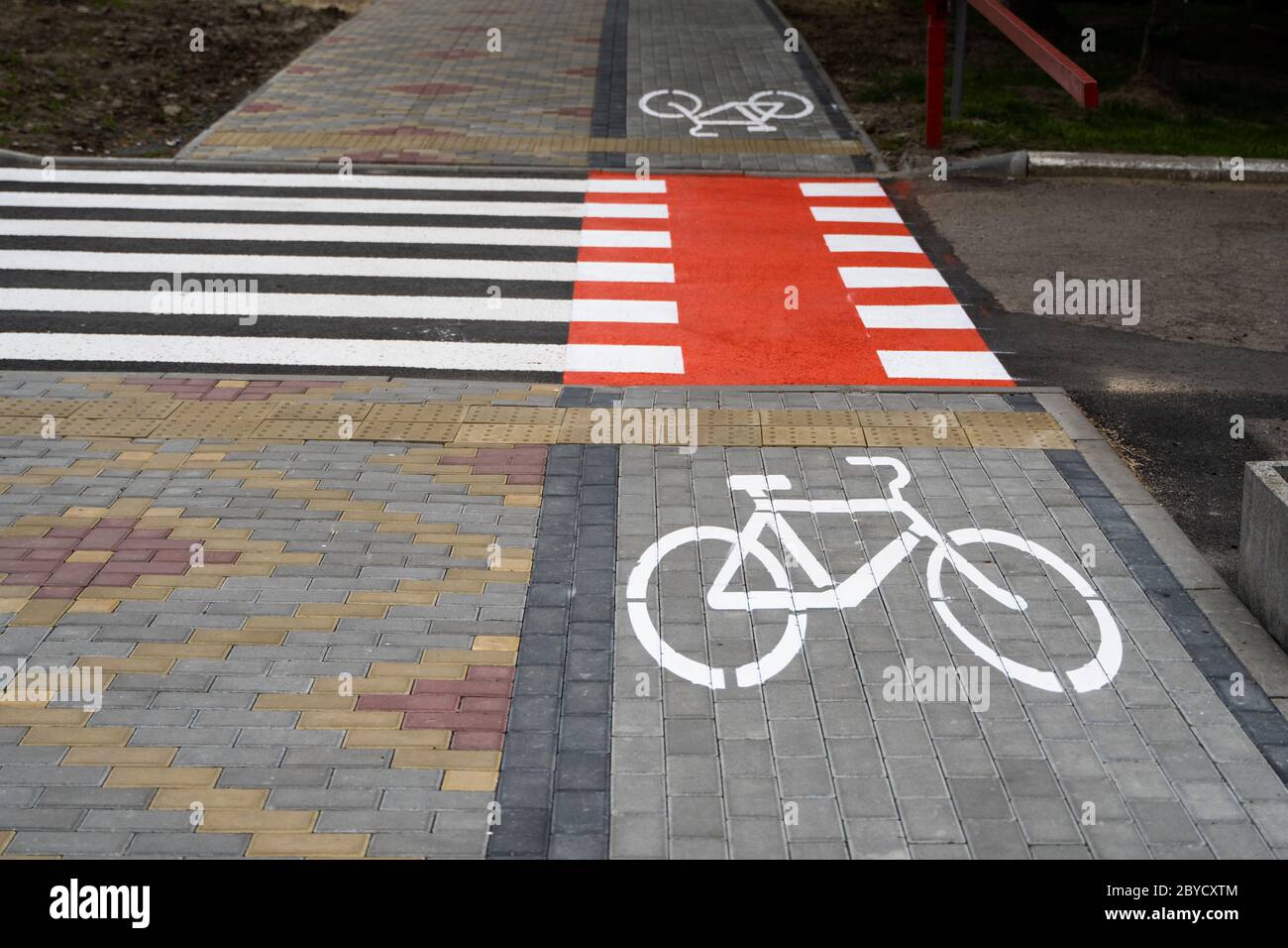 Cycling path with a symbol of bike on a ground through avtomobile road ...