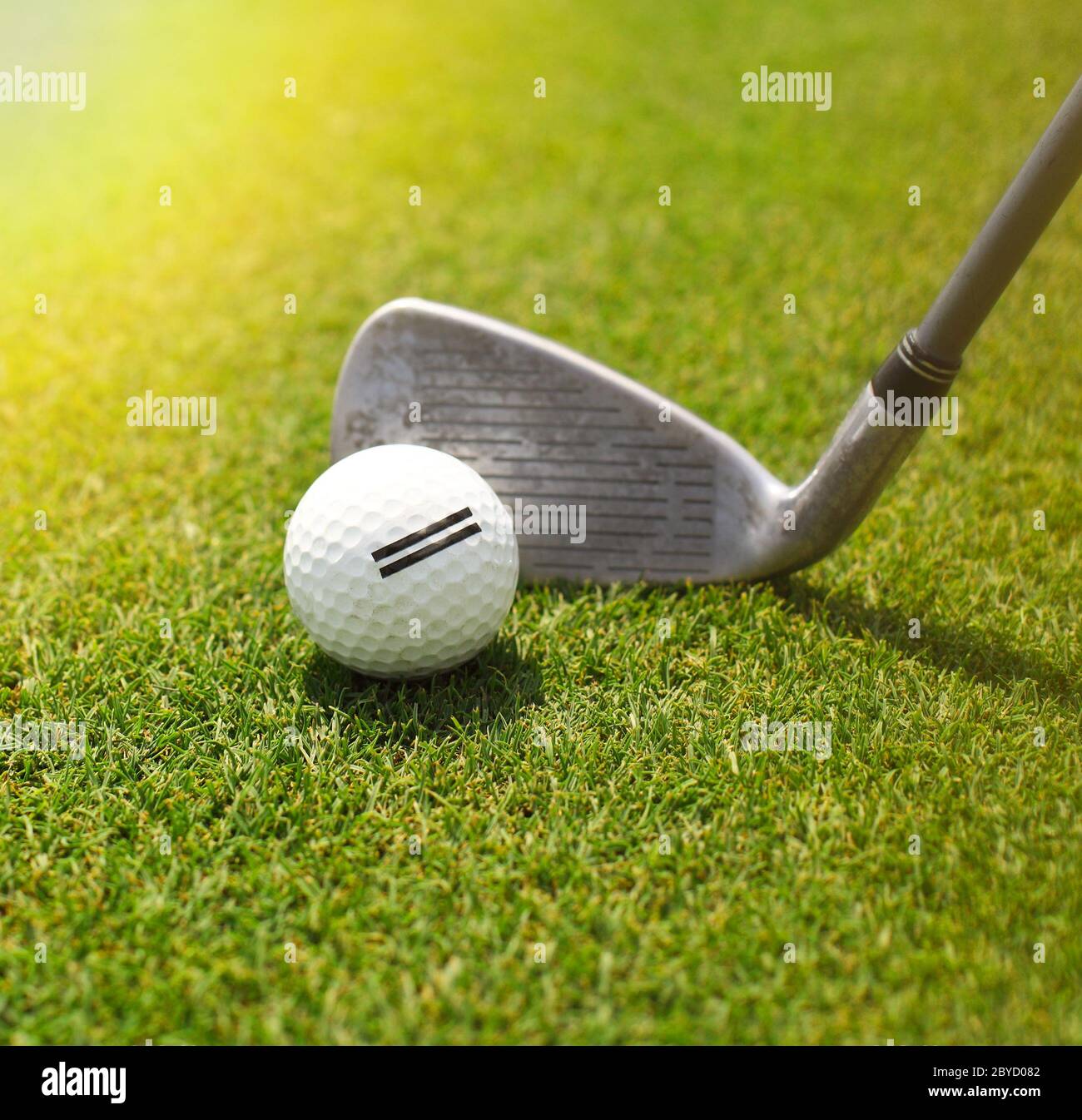 Golf player hitting the ball into the whole Stock Photo - Alamy