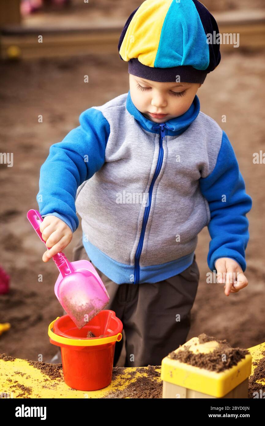 Boy Playing in Sandbox Stock Photo - Alamy