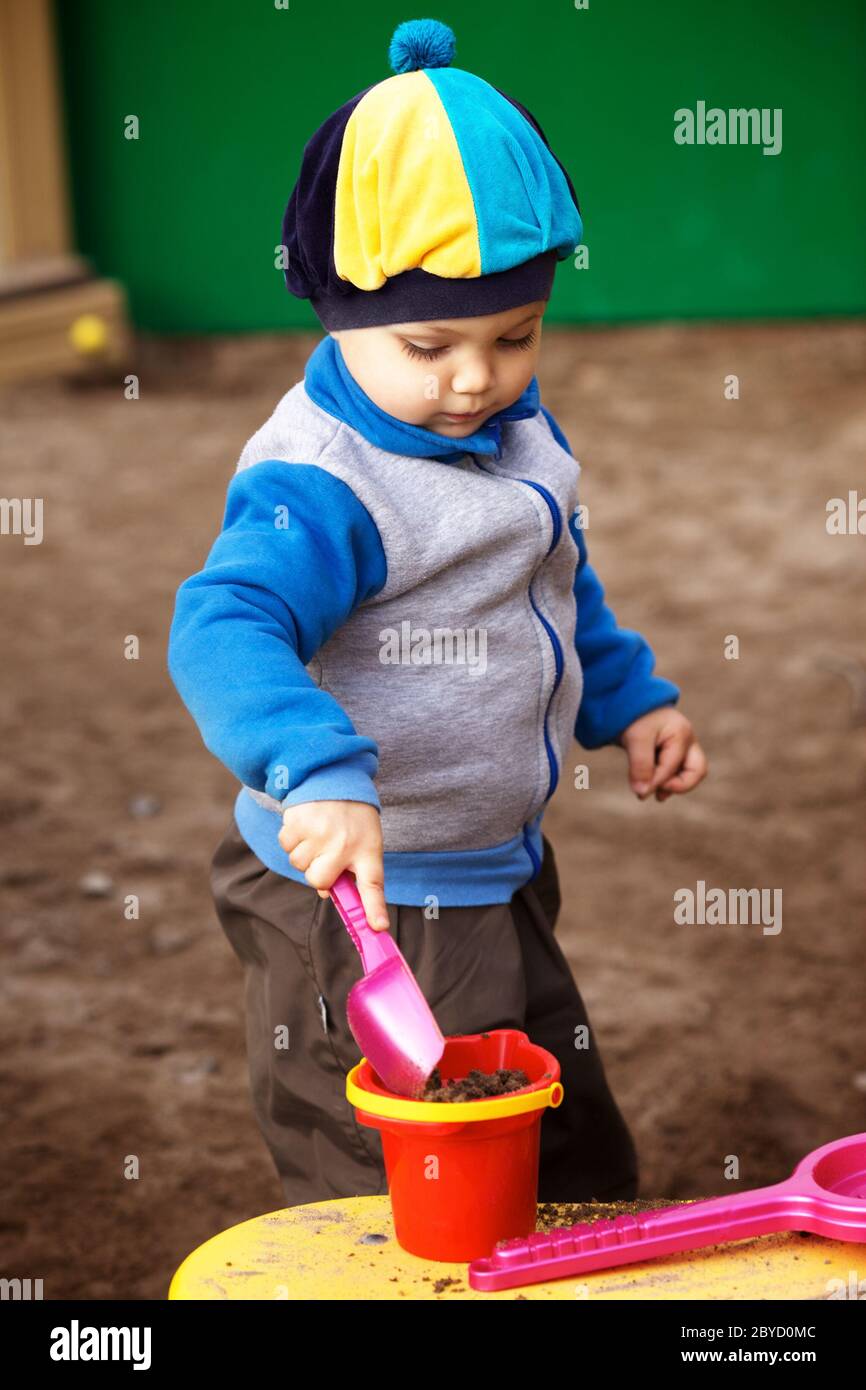 Boy Playing in Sandbox Stock Photo - Alamy