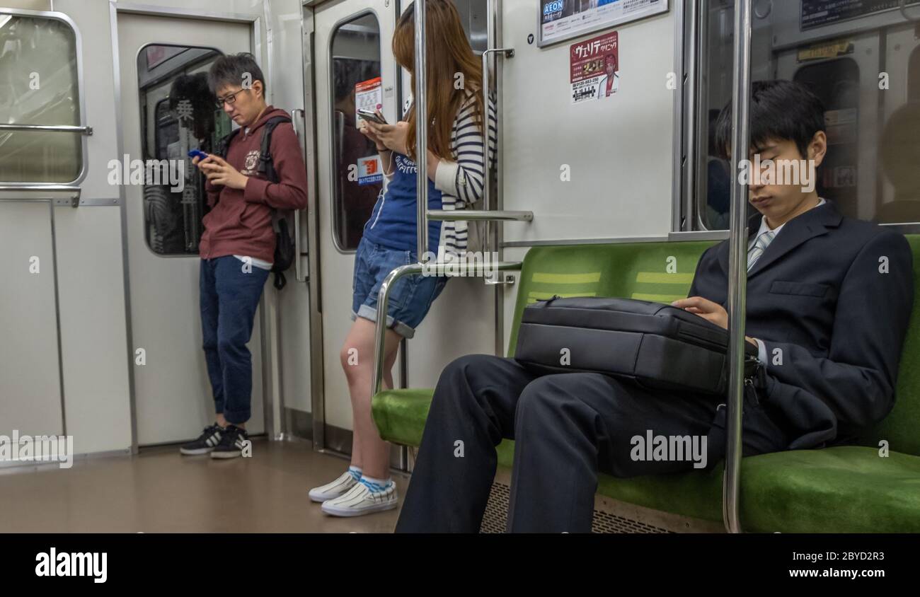 Passengers commuting in commuter train, Tokyo, Japan Stock Photo - Alamy