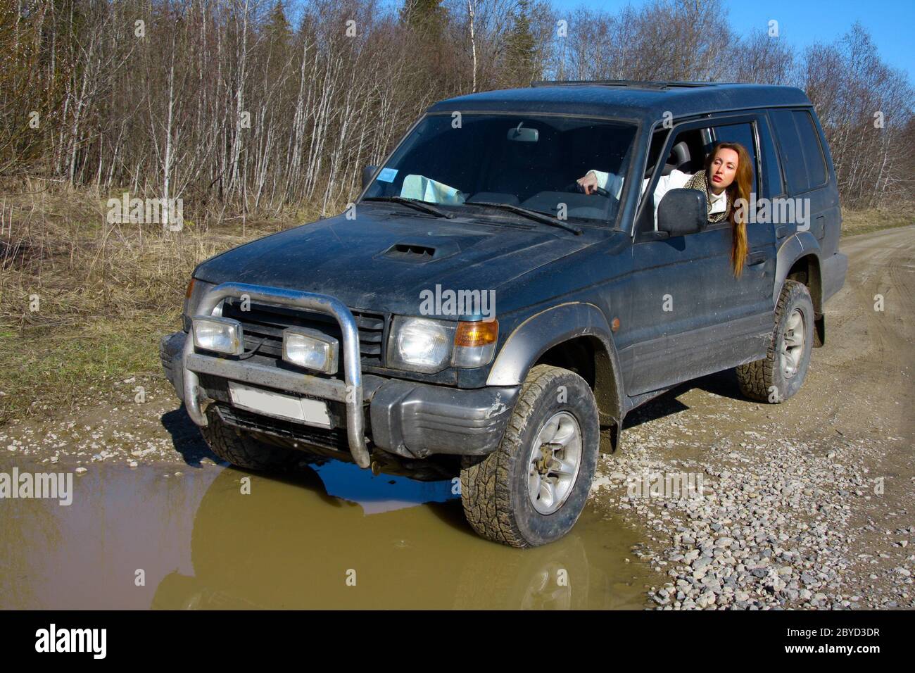 Young woman behind rudder of offroad car Stock Photo - Alamy