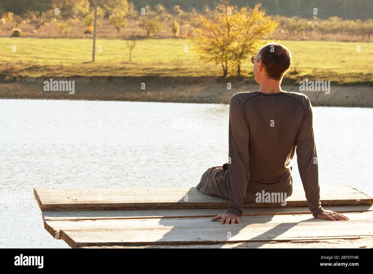 Man resting on lake Stock Photo - Alamy
