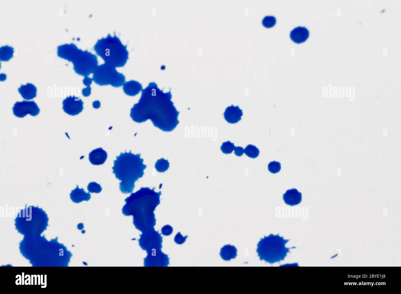 Blue splatter on white background Stock Photo - Alamy