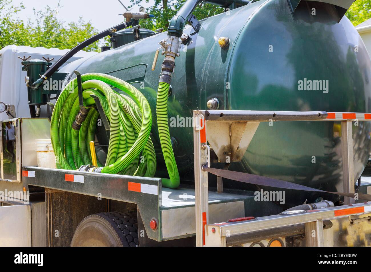 Vacuum waste truck on the cleaning process portable bio toilet cabins ...