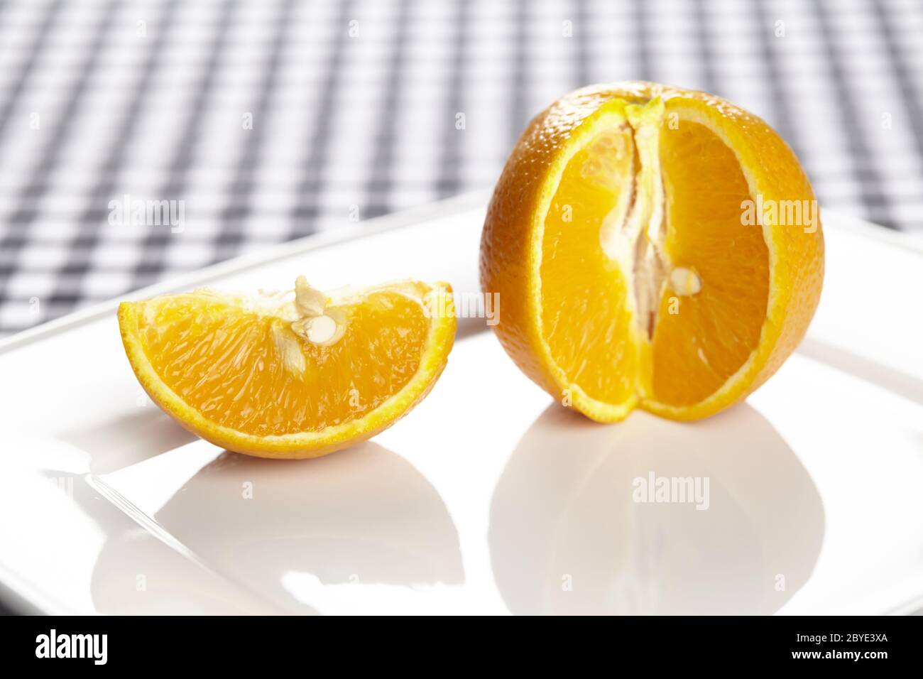 Orange with quarter Stock Photo - Alamy