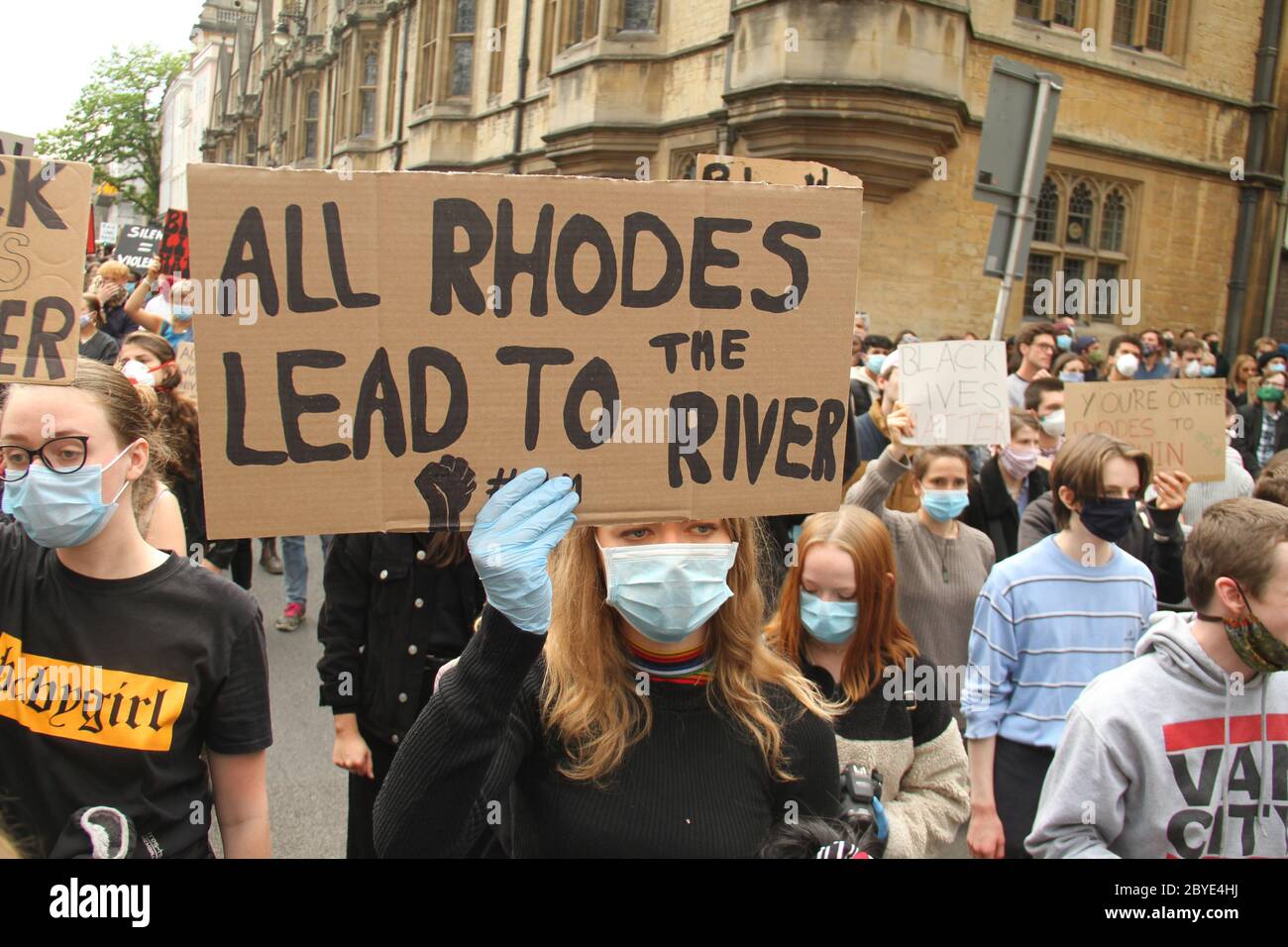 A protester holds a placard that says All Rhodes Lead to the River ...
