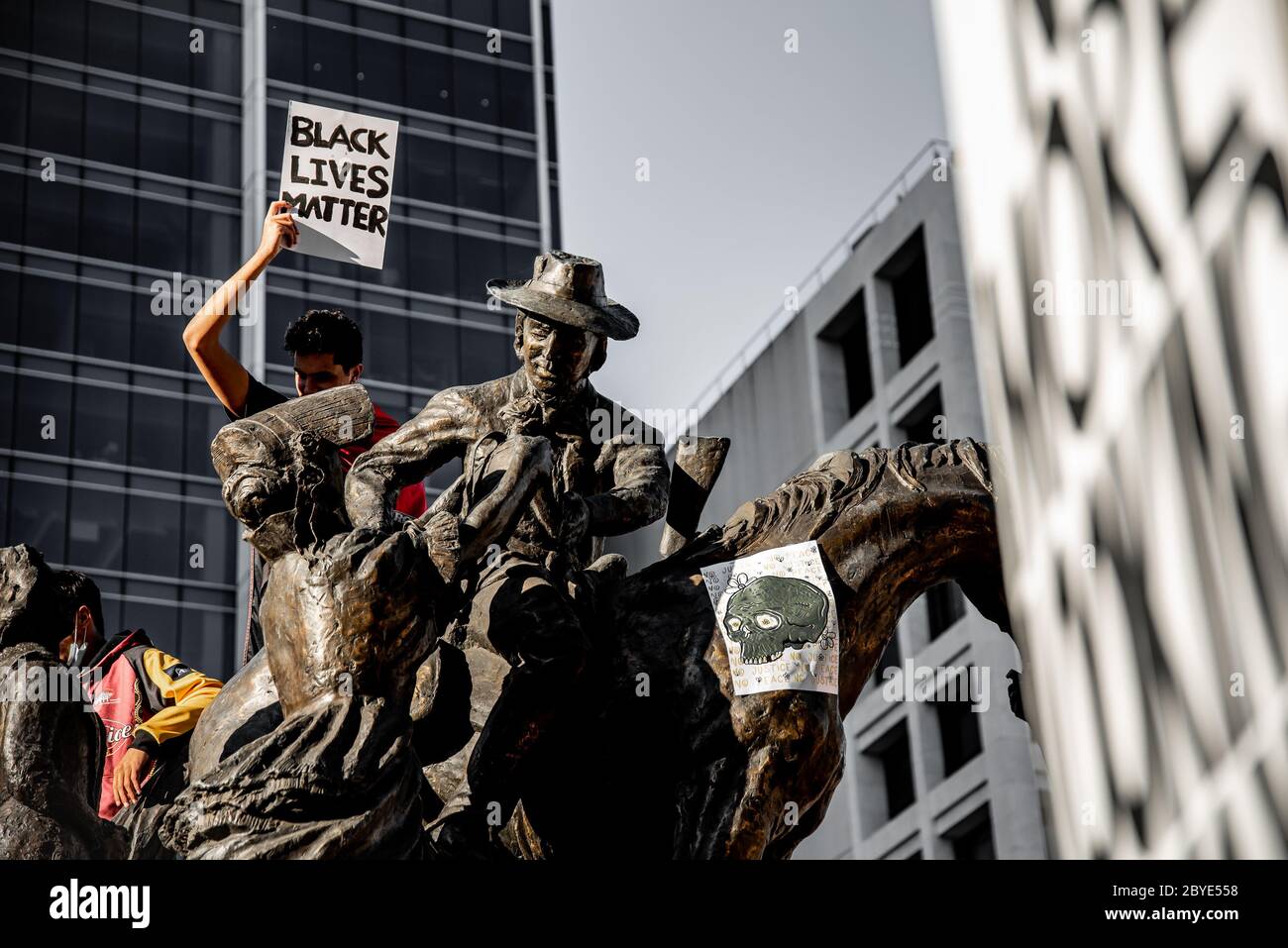 Young men climb statue at BLM protest, King George Square Stock Photo ...