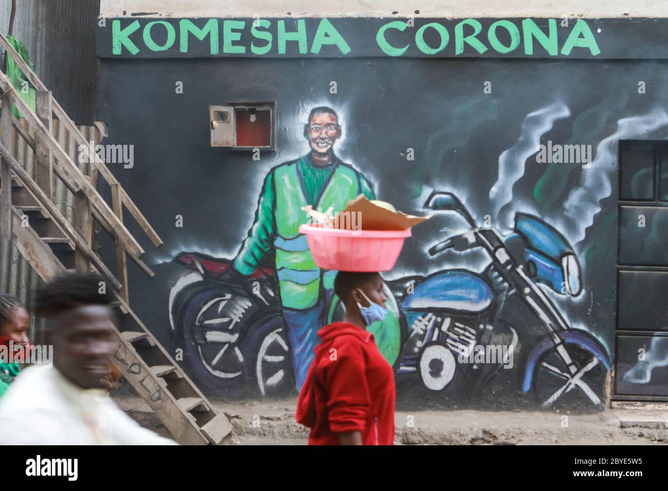 Woman walks past mural depicting hi-res stock photography and images ...