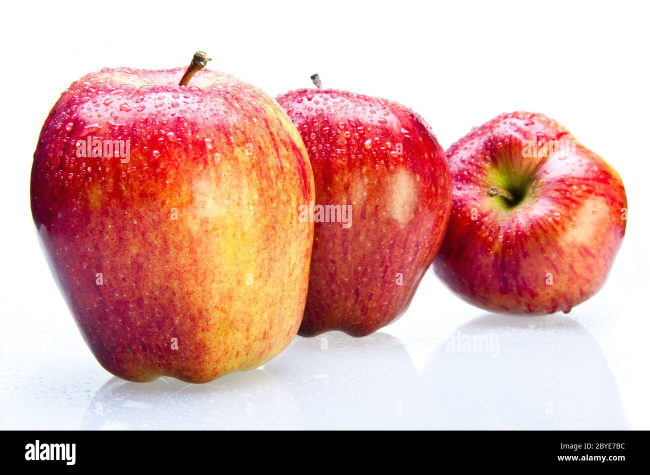 Three juicy apples lay in a number Stock Photo - Alamy