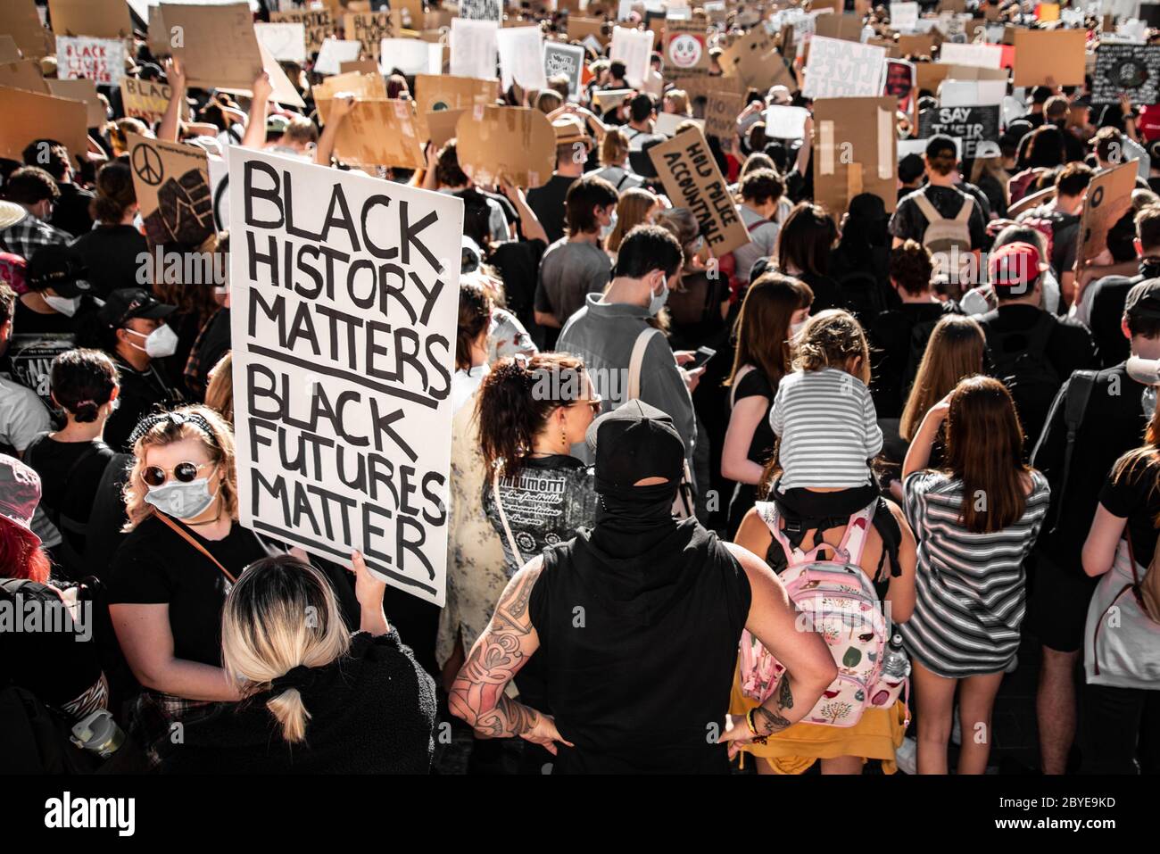 Woman holds sign at BLM protest Stock Photo - Alamy
