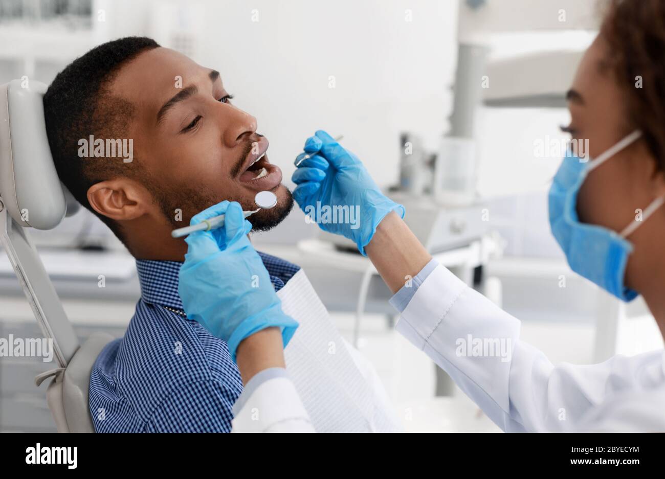 Patient with open mouth having dental treatment Stock Photo - Alamy