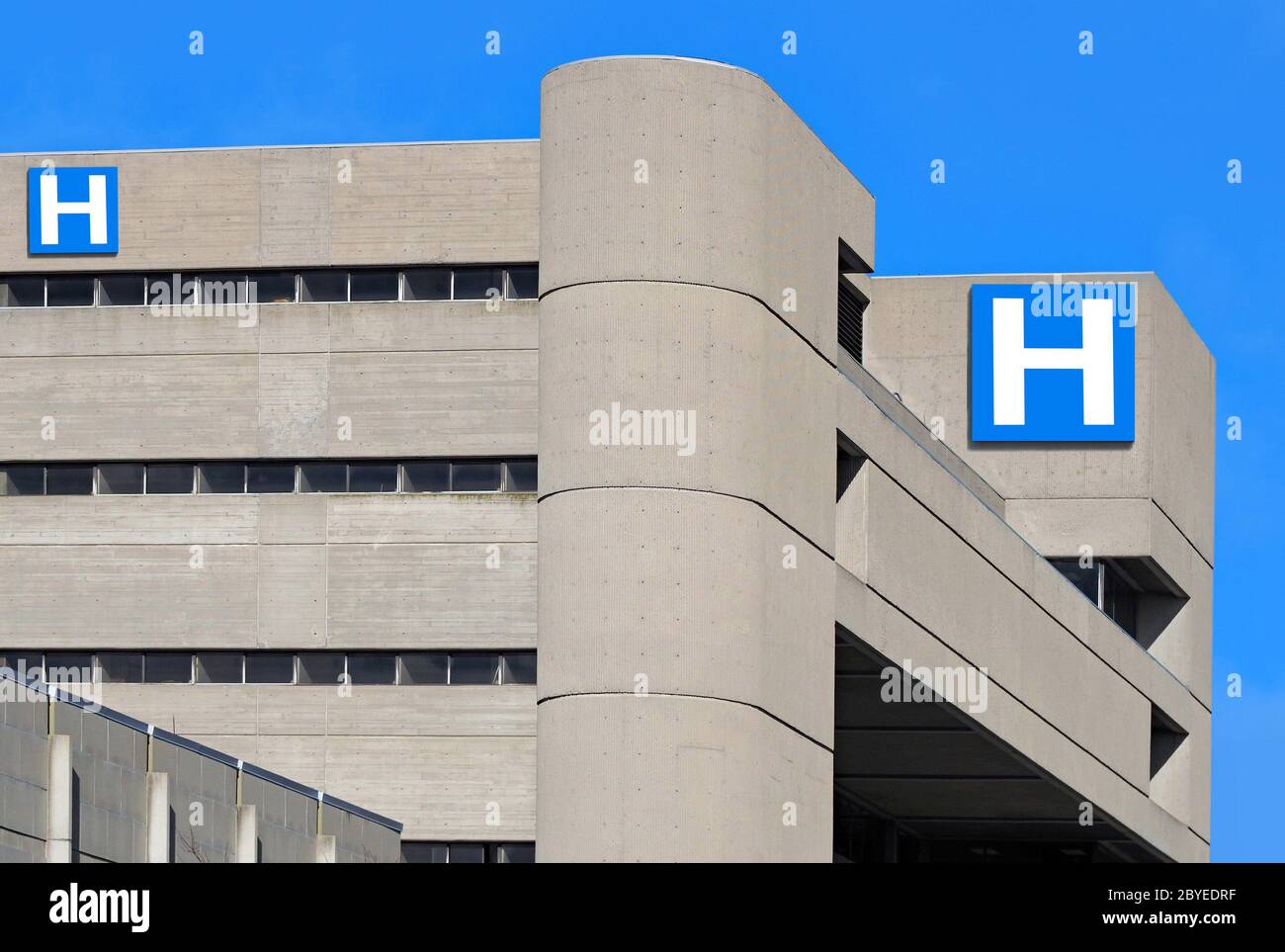 large modern building with blue letter H sign for hospital Stock Photo ...