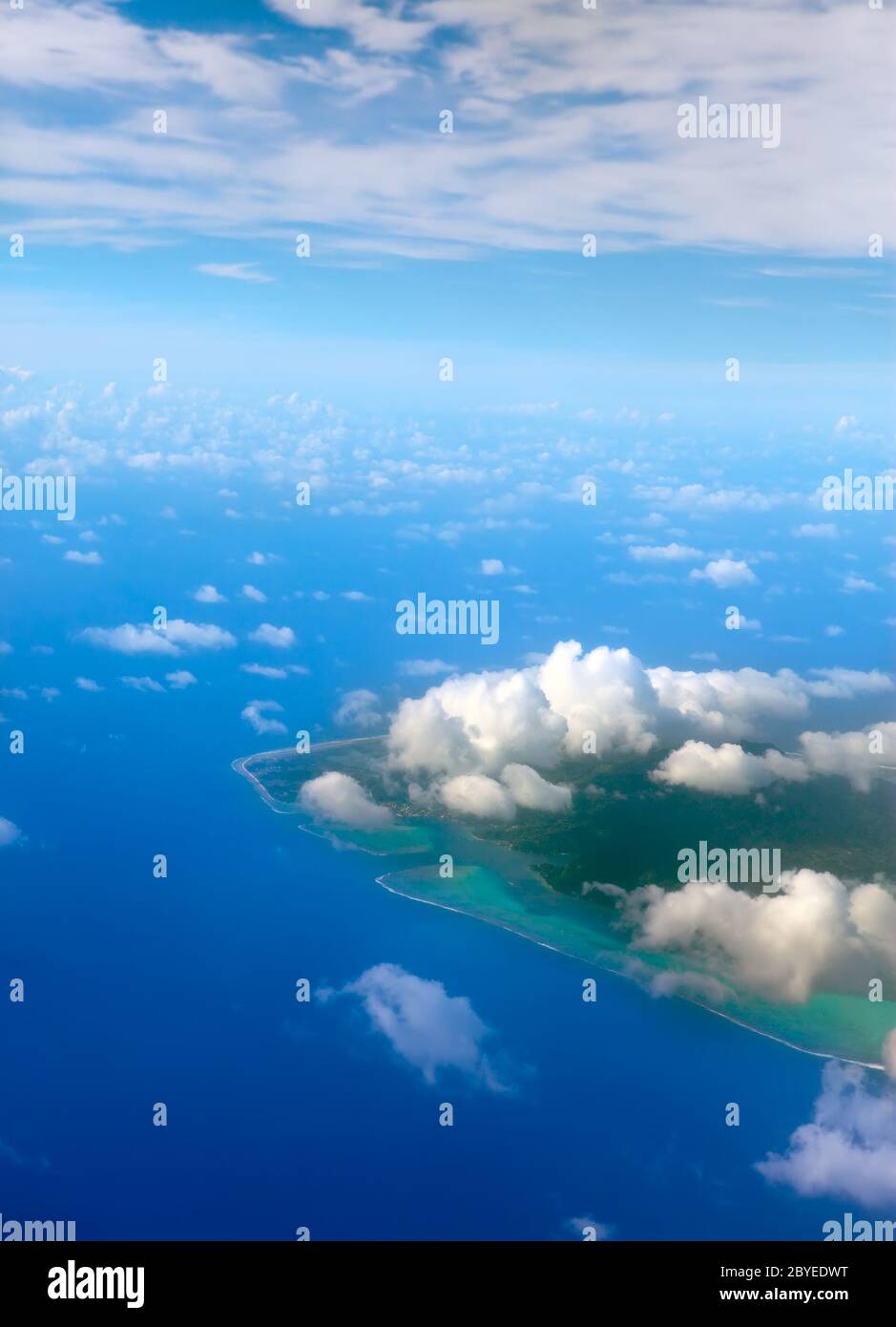 The atoll ring in ocean is visible through clouds Stock Photo - Alamy