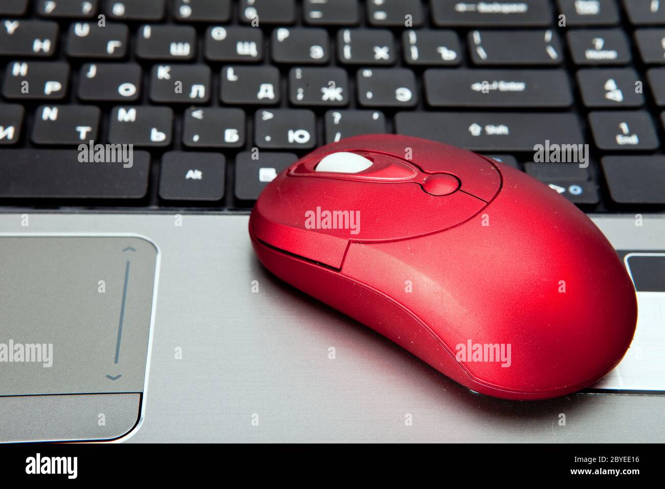The red computer mouse on the black keyboard Stock Photo - Alamy