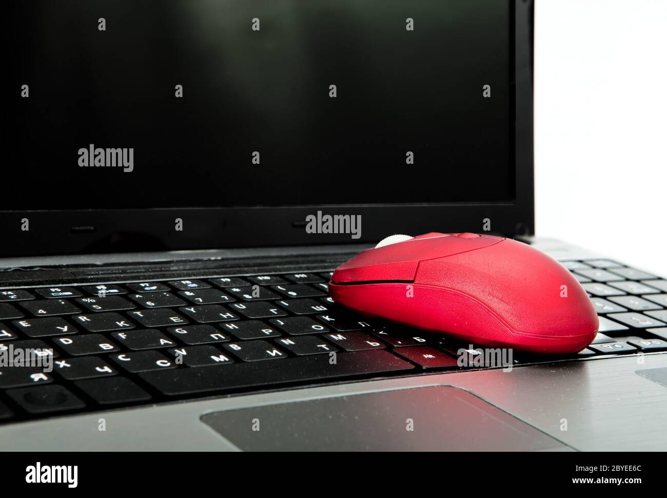 The red computer mouse on the black keyboard Stock Photo - Alamy