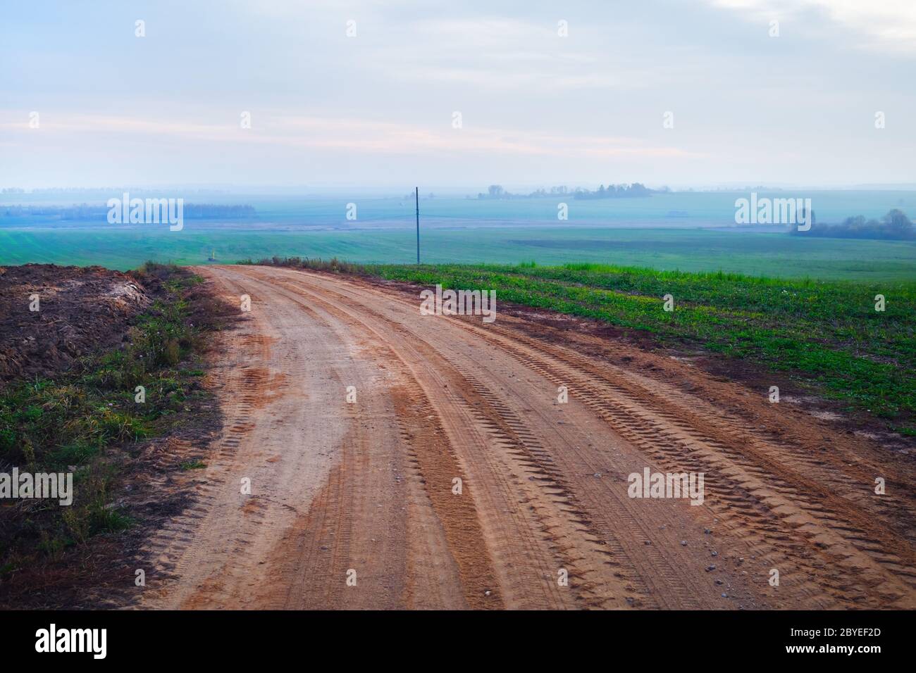Gravel road turn. Evening in the countryside. Rural landscape Stock ...