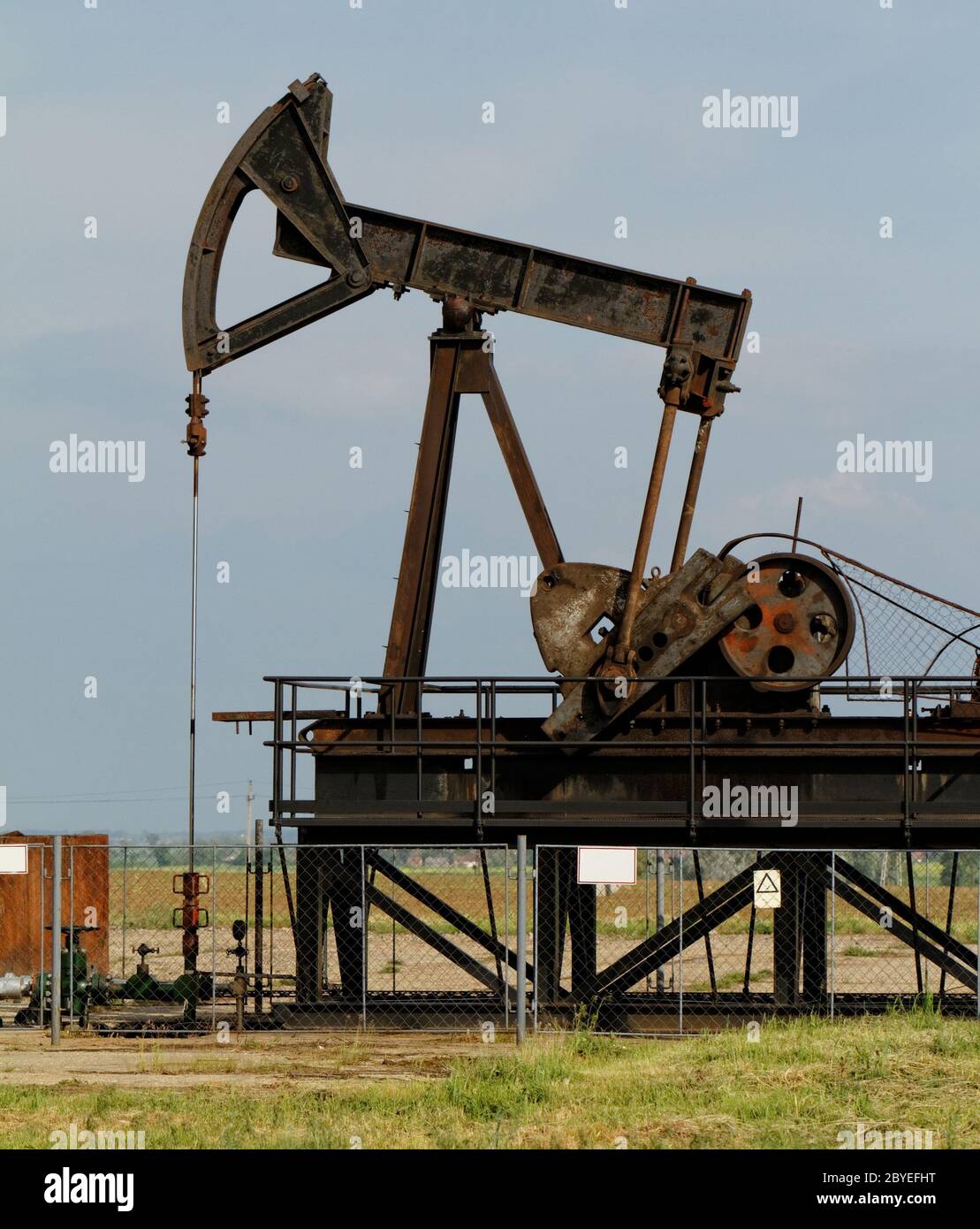 Operating oil and gas well on the meadow Stock Photo - Alamy