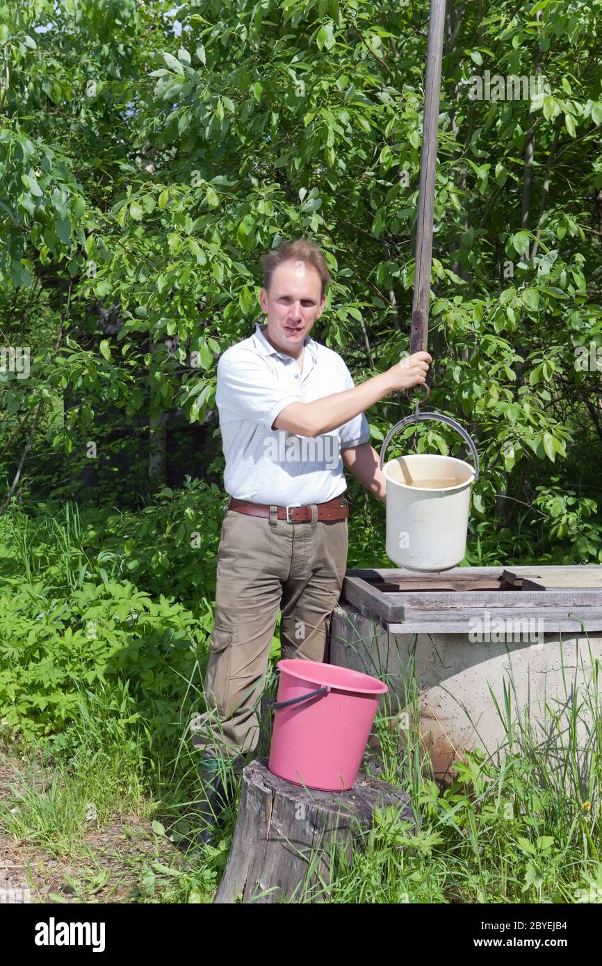 Man bucket water hi-res stock photography and images - Alamy