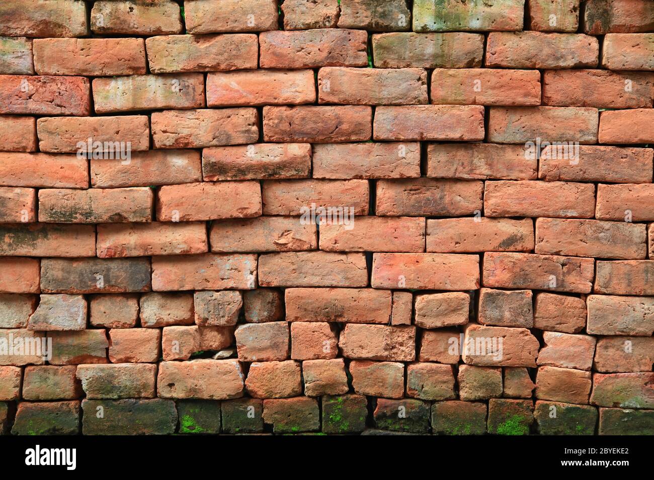 irregular shapes of red stone brick wall background Stock Photo - Alamy