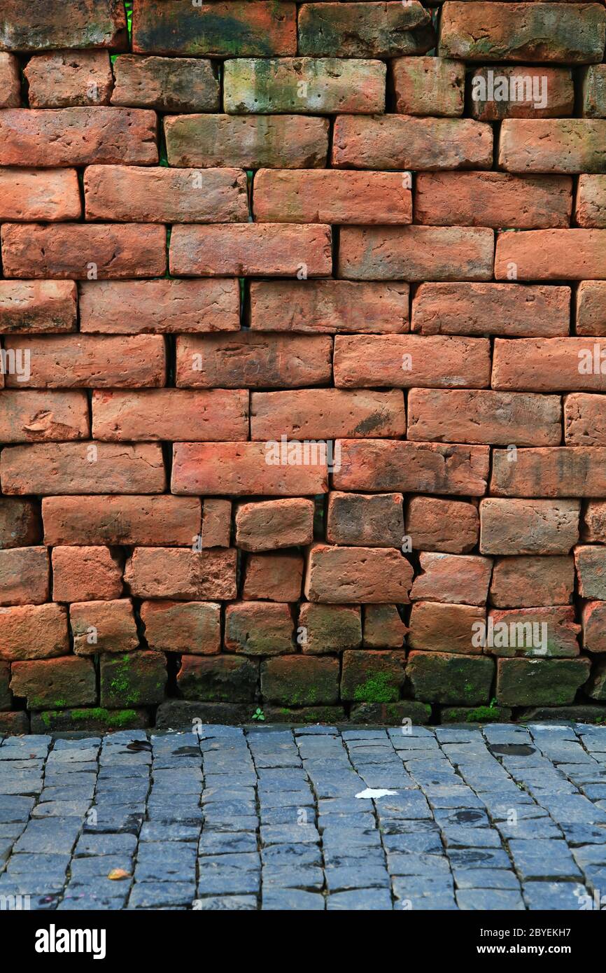 irregular shapes of red stone brick wall with pavement Stock Photo - Alamy