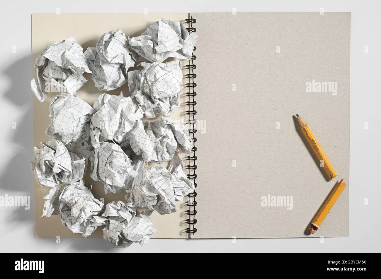 Notepad, broken pencil and crumpled paper balls on white background ...